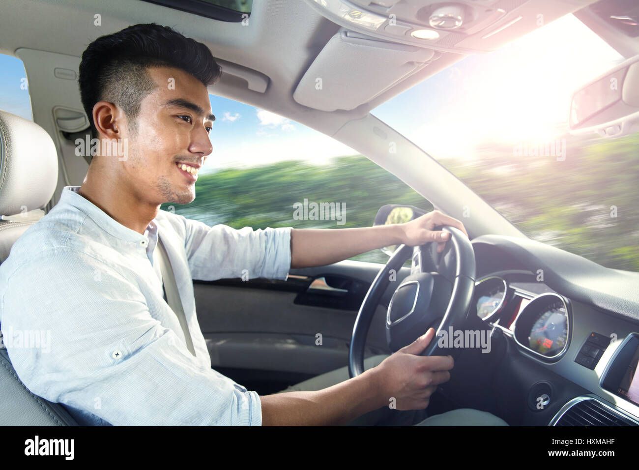 Young man driving a car Stock Photo - Alamy