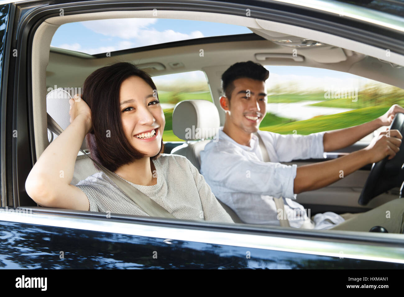 Young couple driving on trip Stock Photo - Alamy