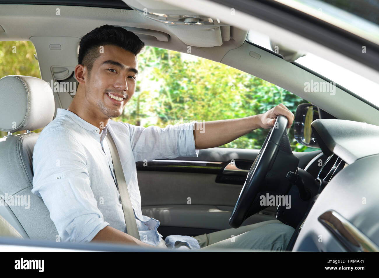Young man driving a car Stock Photo - Alamy
