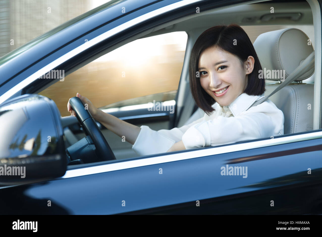 Young woman driving car Stock Photo - Alamy