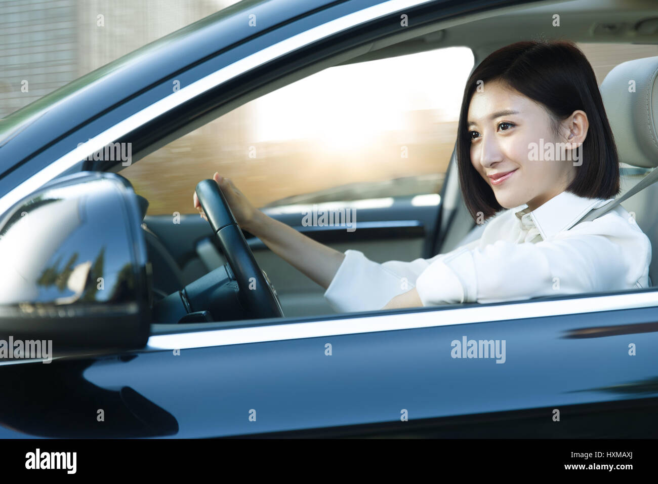 Young woman driving car Stock Photo - Alamy