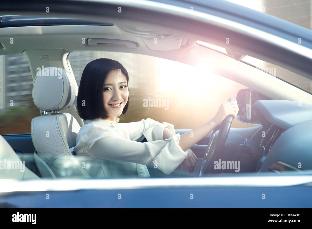 Young woman driving car Stock Photo - Alamy