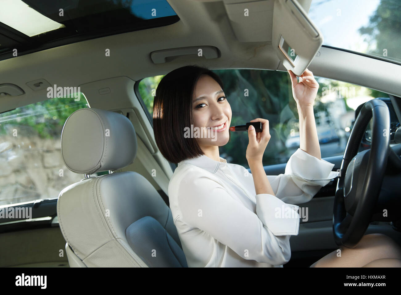 Young woman make up in car Stock Photo - Alamy