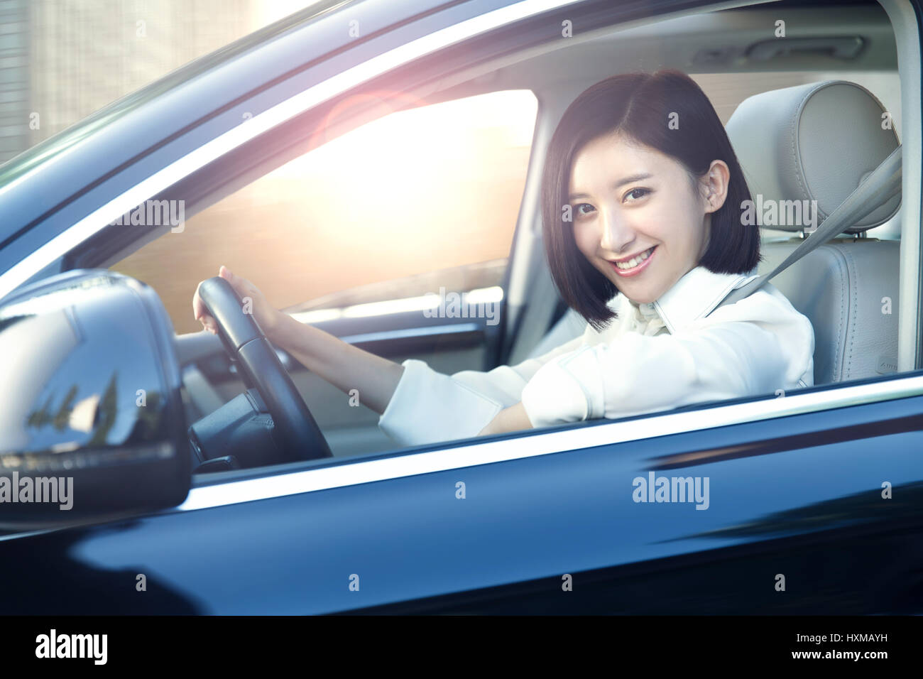 Young woman driving car Stock Photo - Alamy