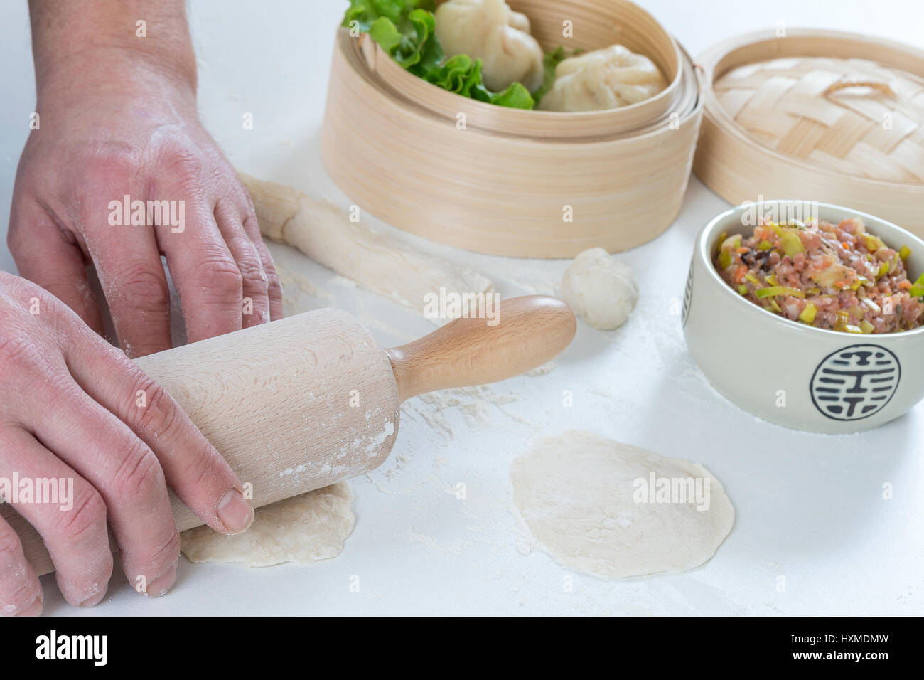 Hands preparing homemade dim-sum asian dumplings buns Stock Photo - Alamy