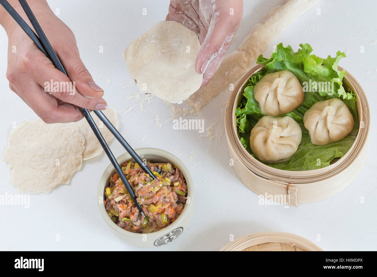 Hands preparing homemade dim-sum asian dumplings buns Stock Photo - Alamy
