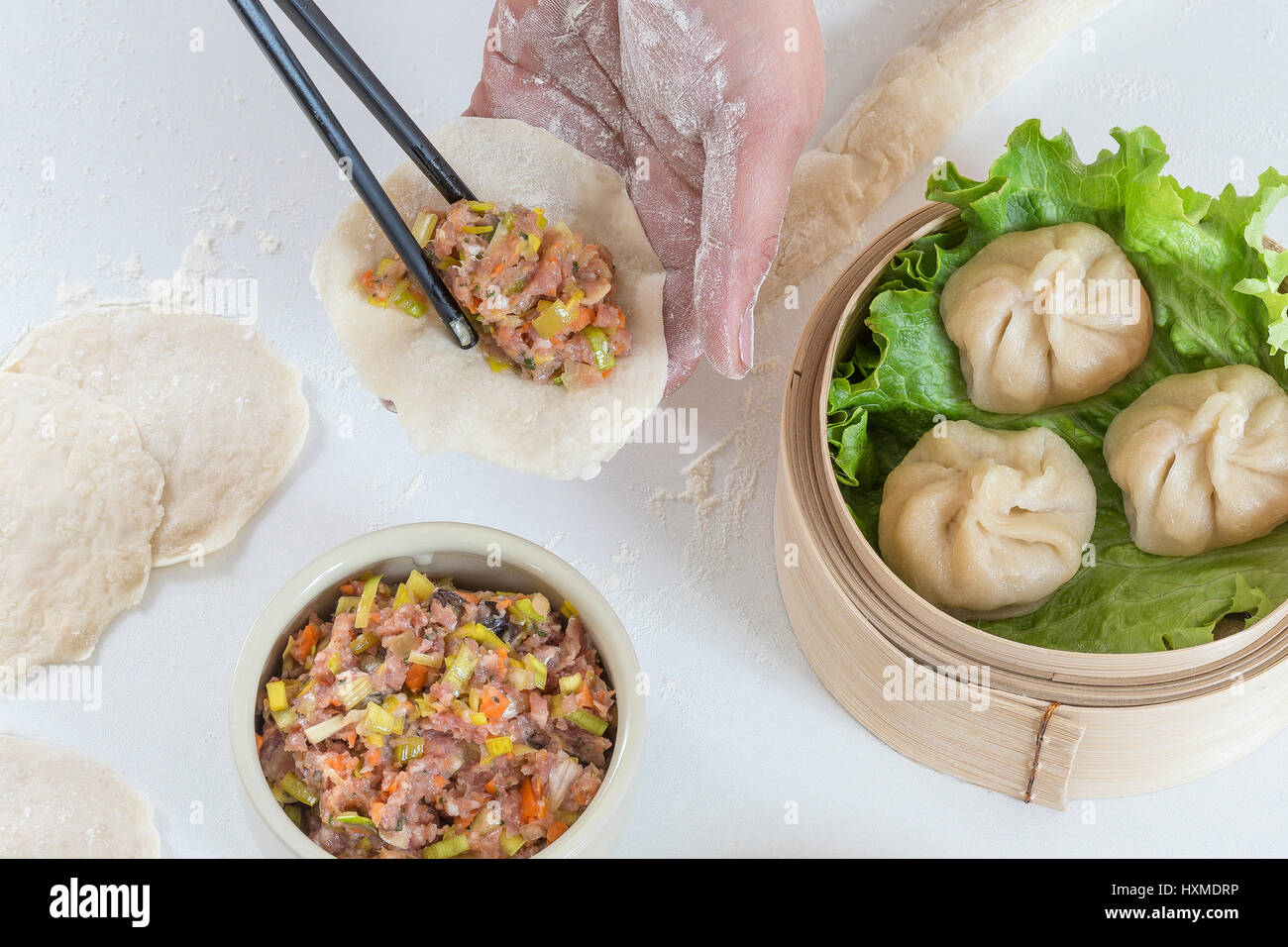 Hands preparing homemade dim-sum asian dumplings buns Stock Photo - Alamy