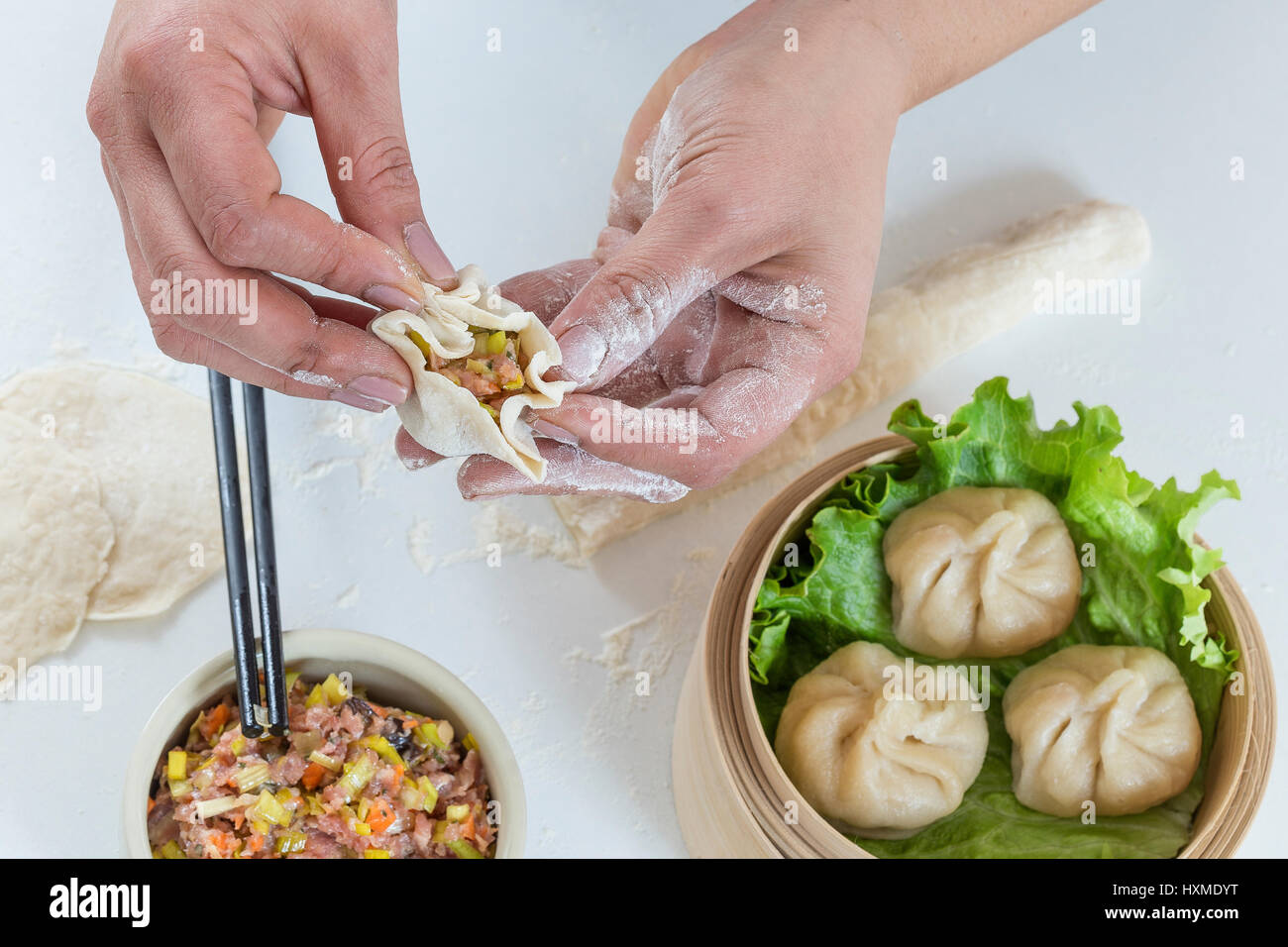 Hands preparing homemade dim-sum asian dumplings buns Stock Photo - Alamy