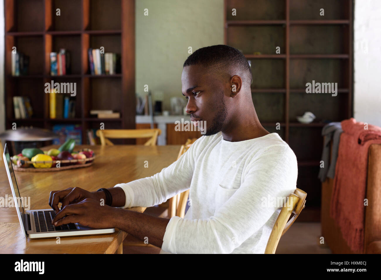 Portrait of a young black man using laptop computer at home Stock Photo ...