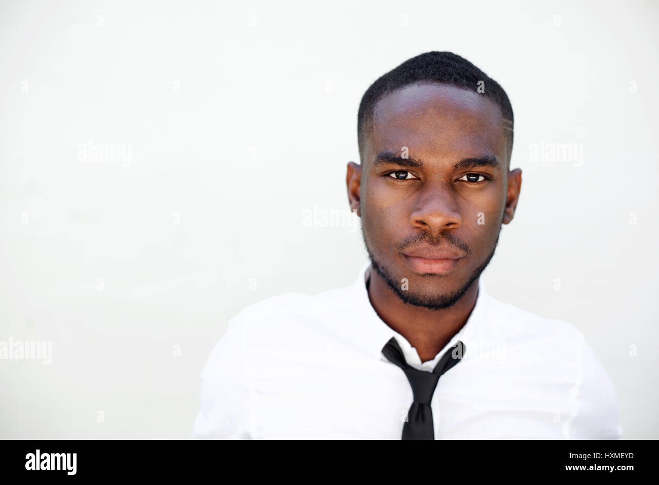 Close up portrait of serious young african man in shirt and tie on ...