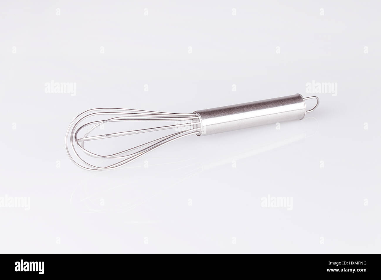 Stainless whisk isolated on white background Stock Photo - Alamy