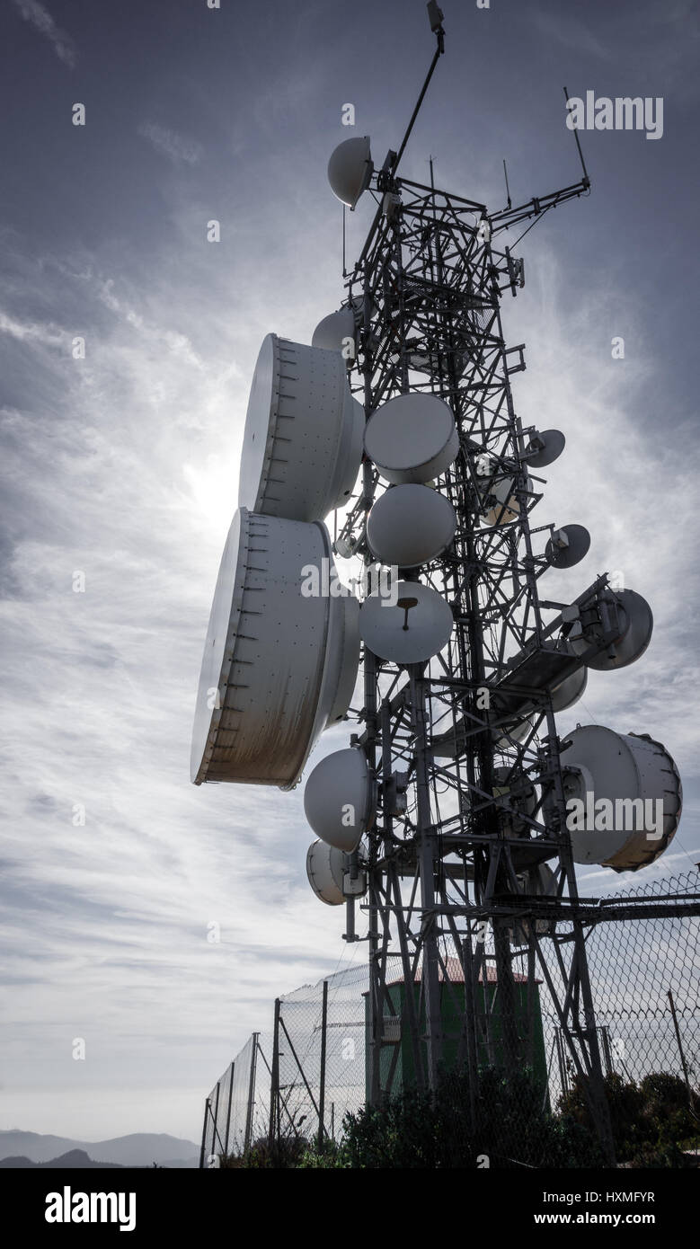 Communication tower backlit against sun Stock Photo - Alamy