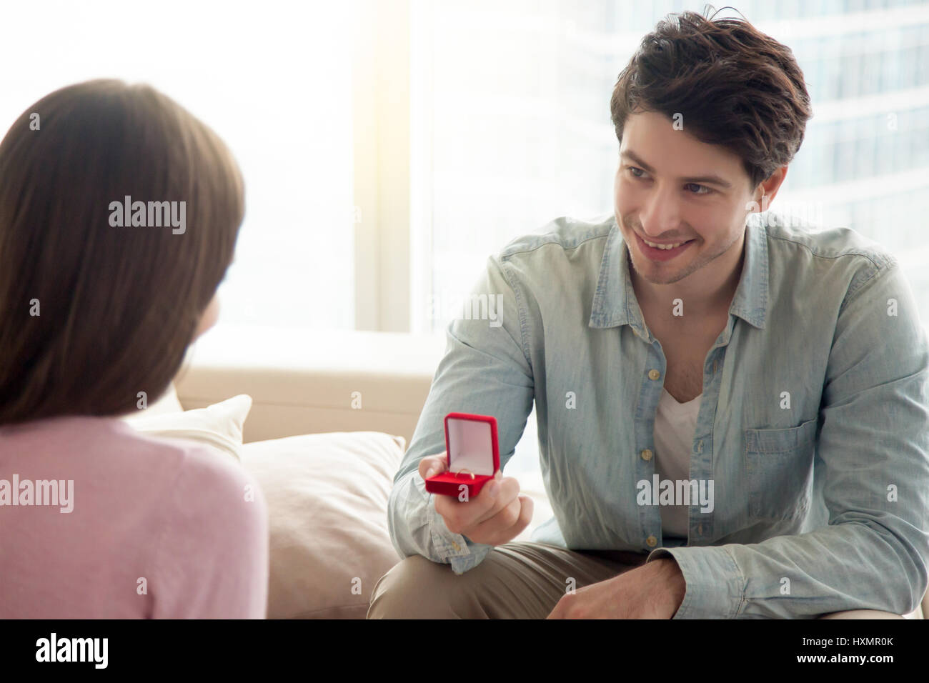 Young man holding engagement ring, making marriage proposal to g Stock ...