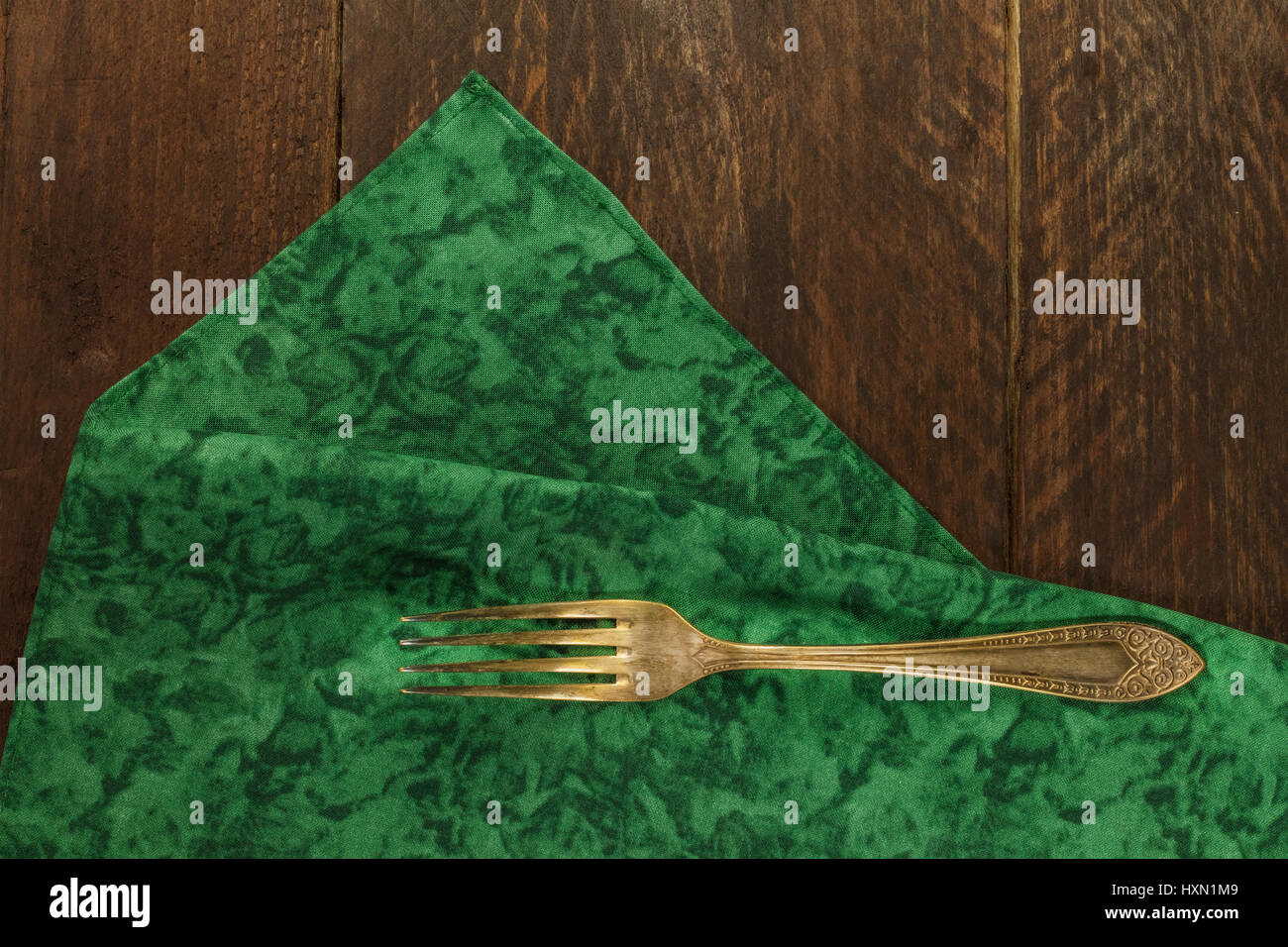 An overhead photo of a vintage fork on a dark wooden background texture ...