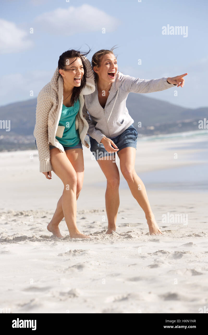 Portrait of two friends laughing and enjoying life at the beach Stock ...