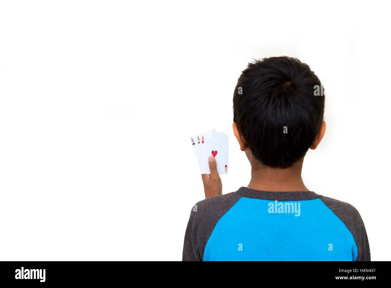 kid holding poker cards on a light background Stock Photo - Alamy