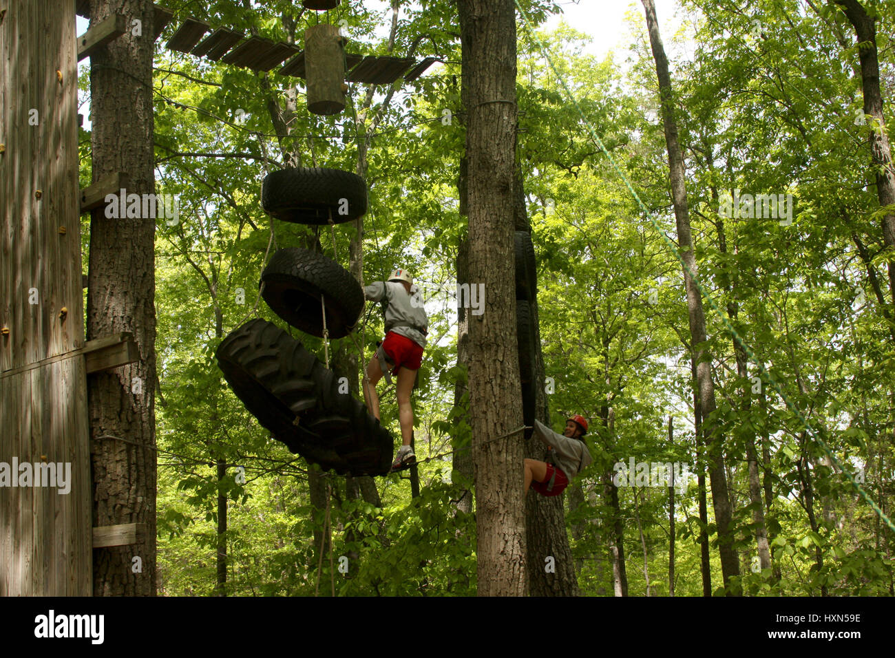 Young girl climbing wall at summer camp Stock Photo - Alamy