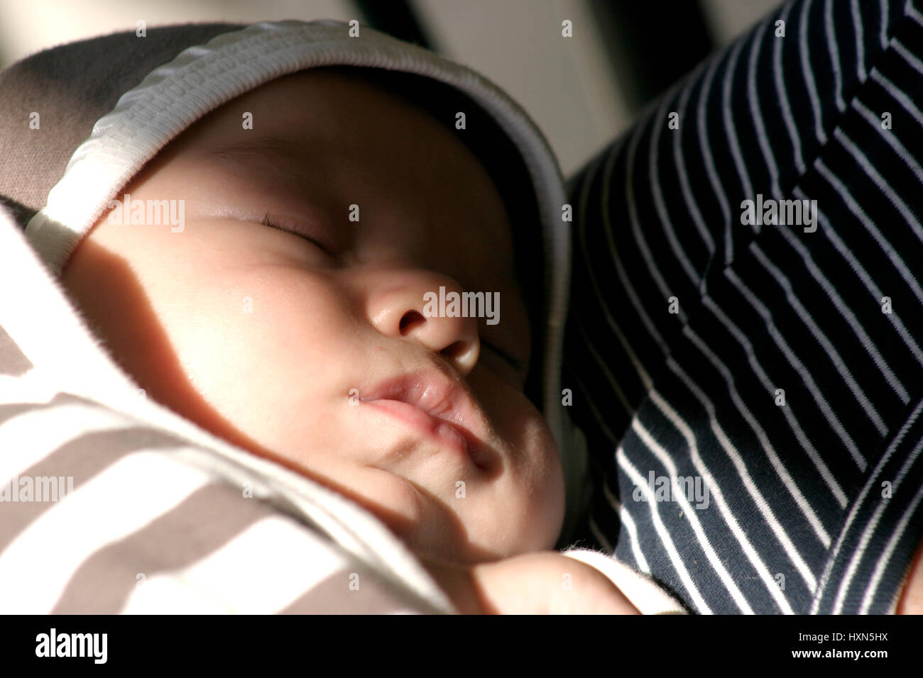 Little baby boy sleeping on his caretaker Stock Photo - Alamy