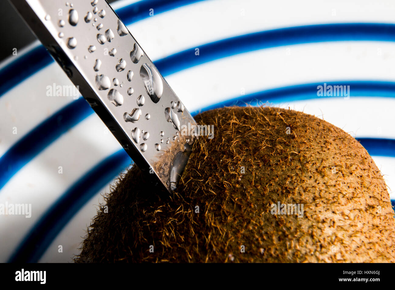 A view of a knife penetrated inside a kiwi - Macrography Stock Photo ...