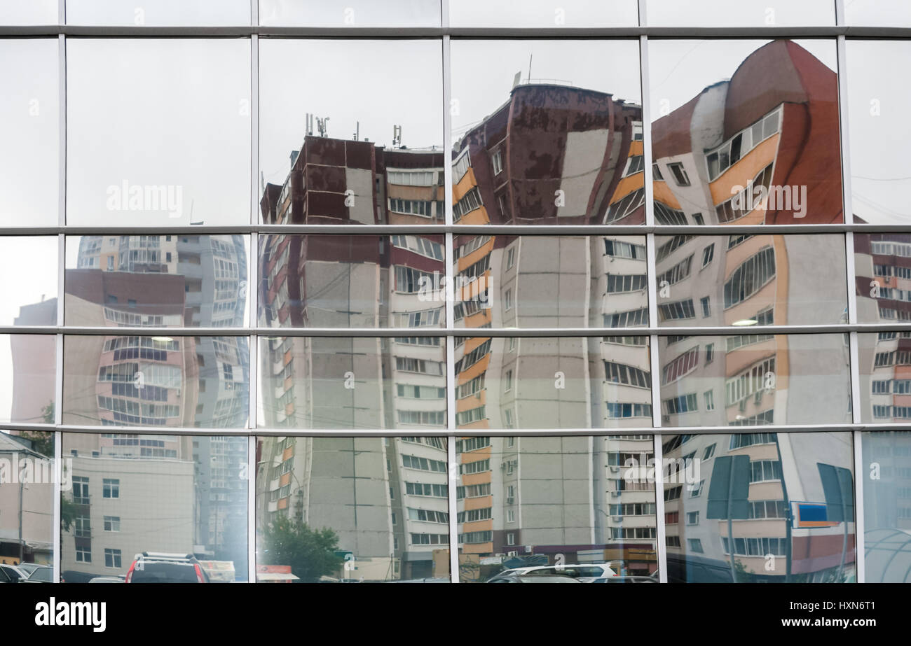 Distorted reflection of several multi-storied residential buildings in ...
