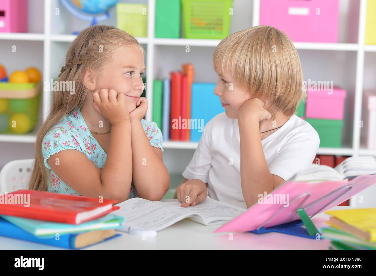 Girl and boy doing lessons Stock Photo - Alamy