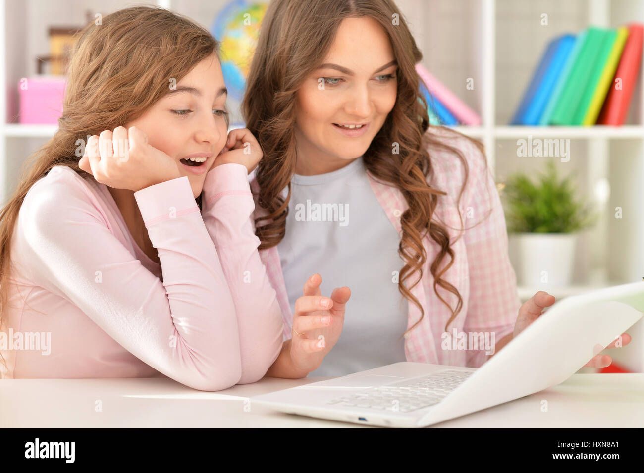 Mother and daughter using laptop Stock Photo - Alamy