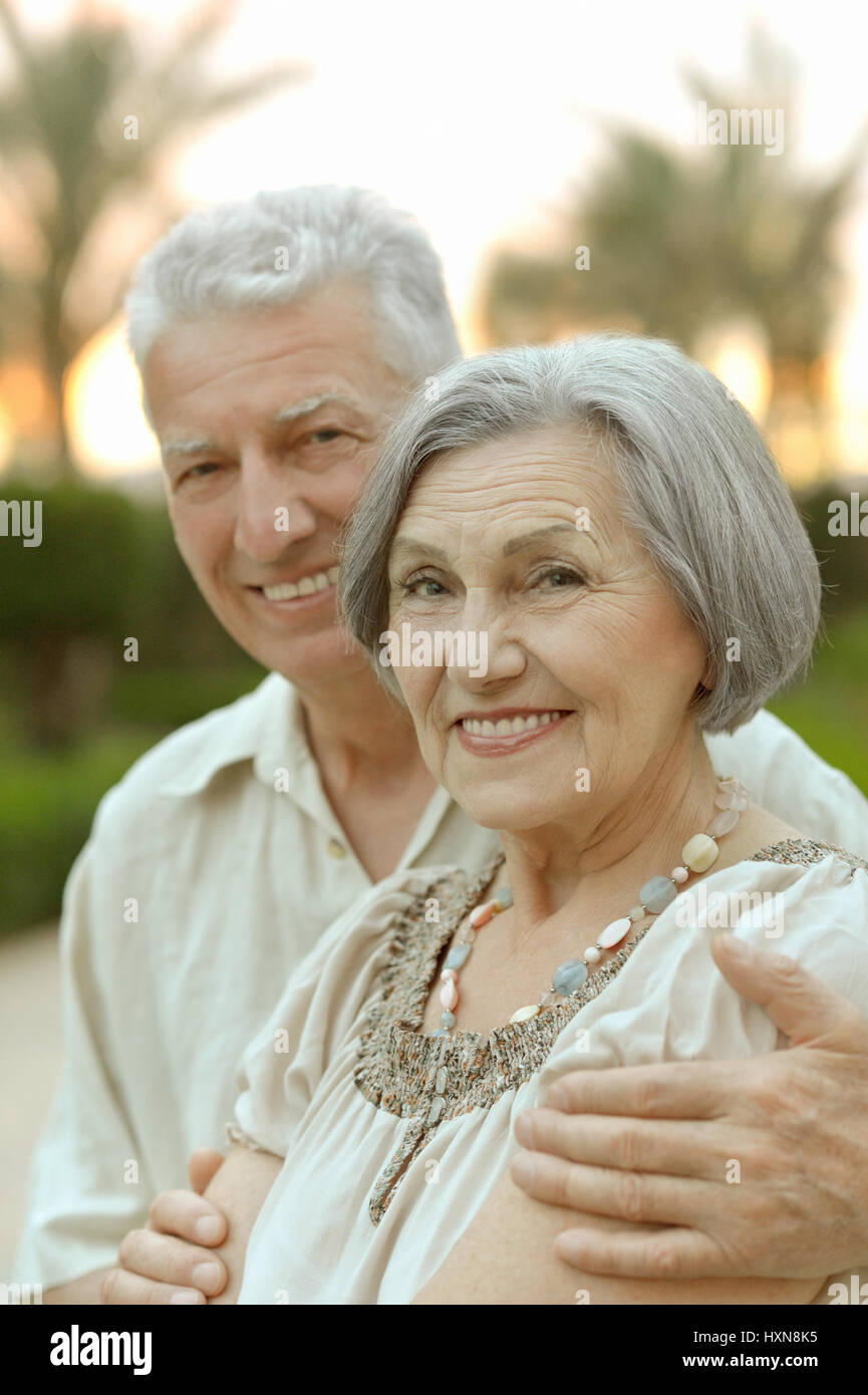 Happy elderly couple embracing Stock Photo - Alamy