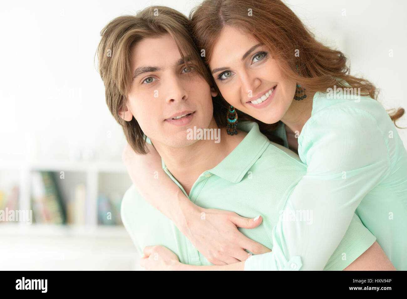 Beautiful young couple hugging Stock Photo - Alamy
