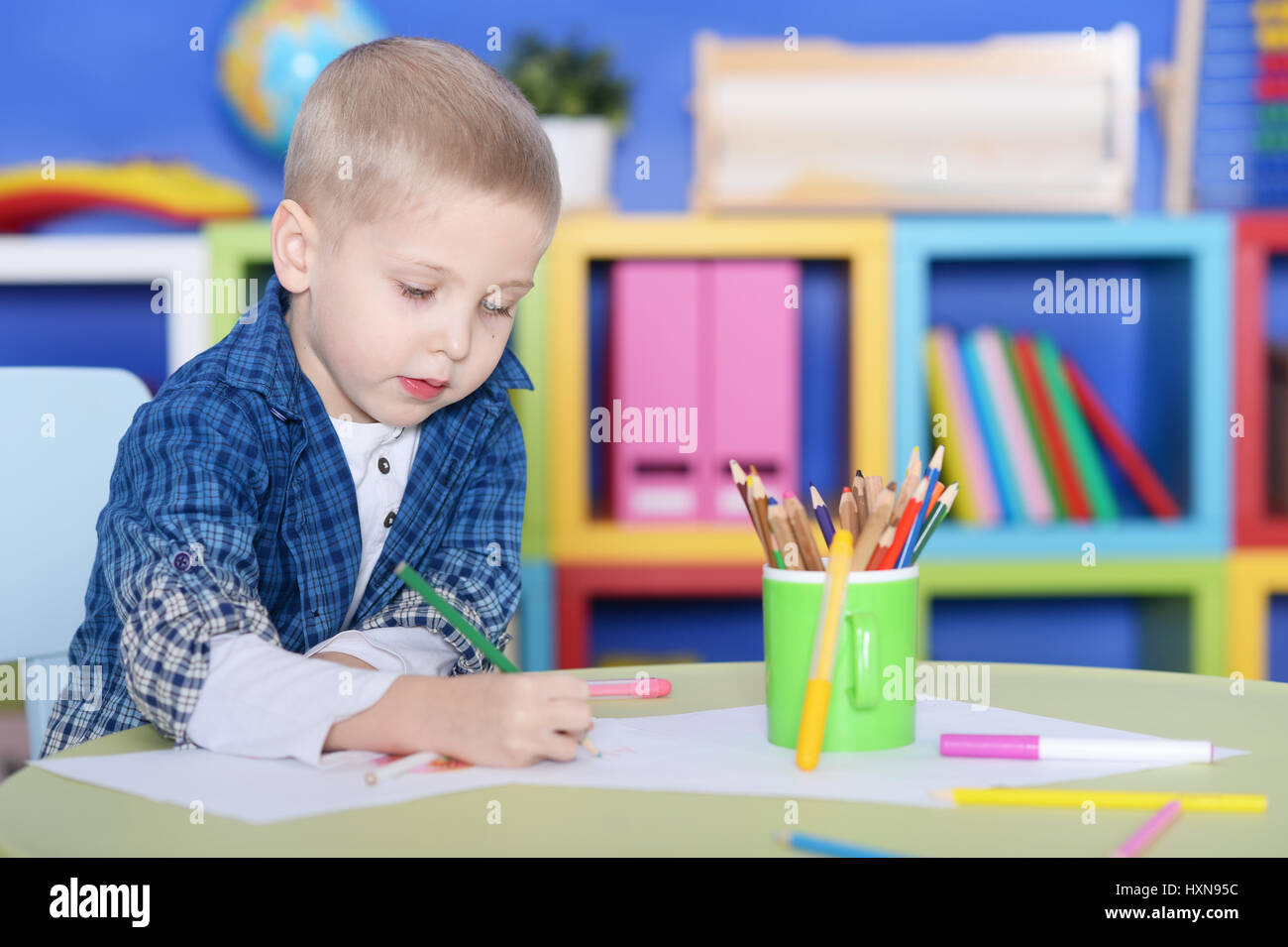 Boy drawing at the table Stock Photo - Alamy