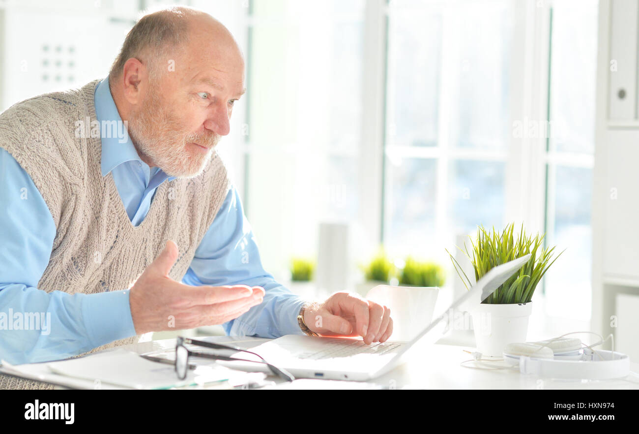 Elderly man with a laptop Stock Photo - Alamy