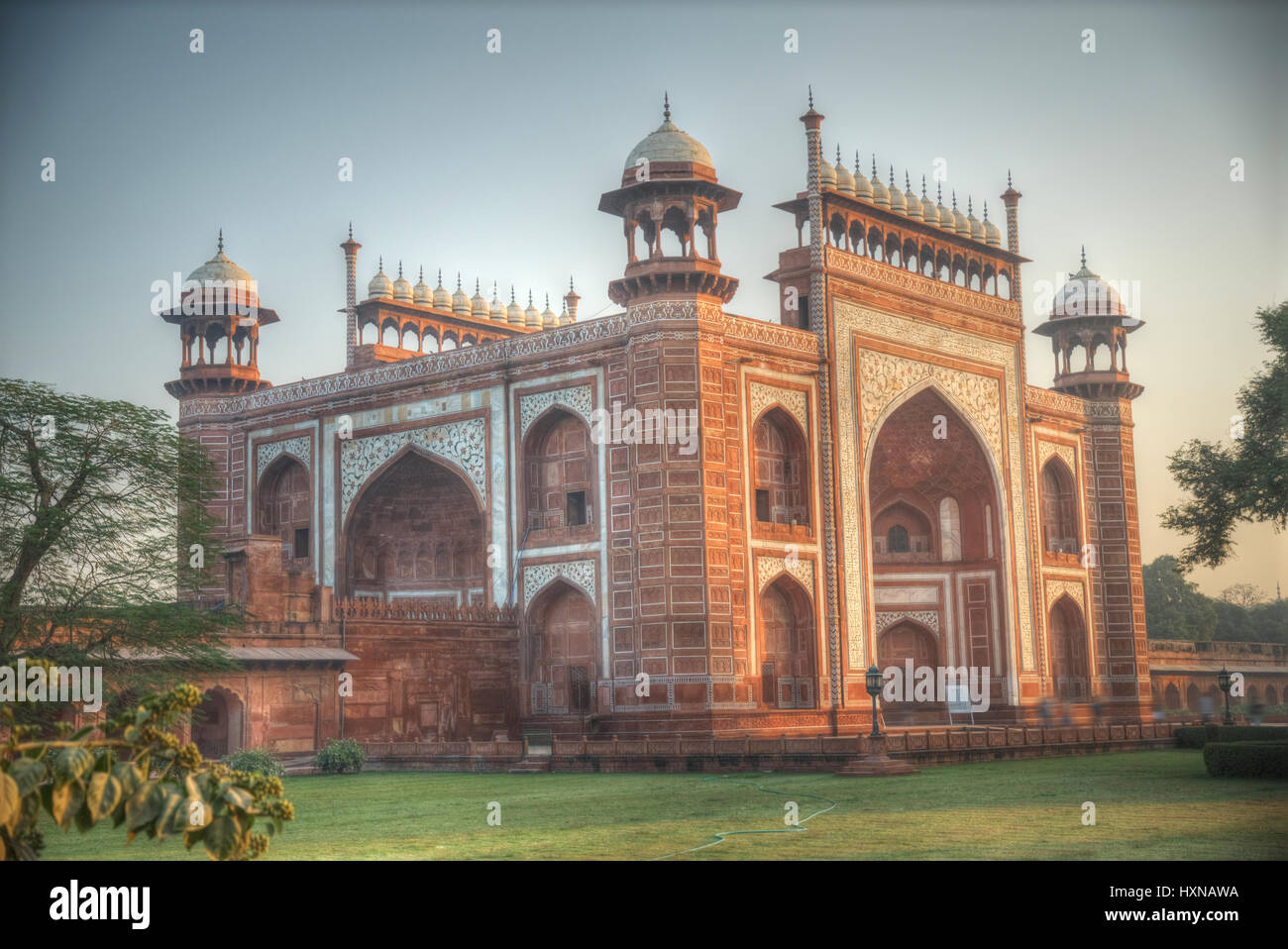 gate through which the Taj Mahal visitors in a park that surrounds the ...