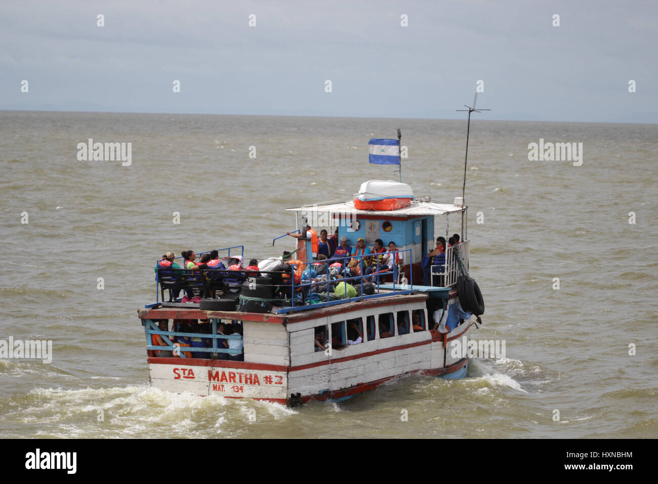 Old wooden ferry with people in central america Stock Photo - Alamy