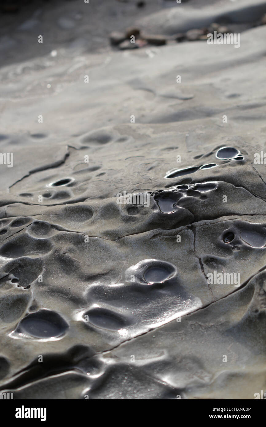 Slippy and wet rock surface next to ocean Stock Photo - Alamy