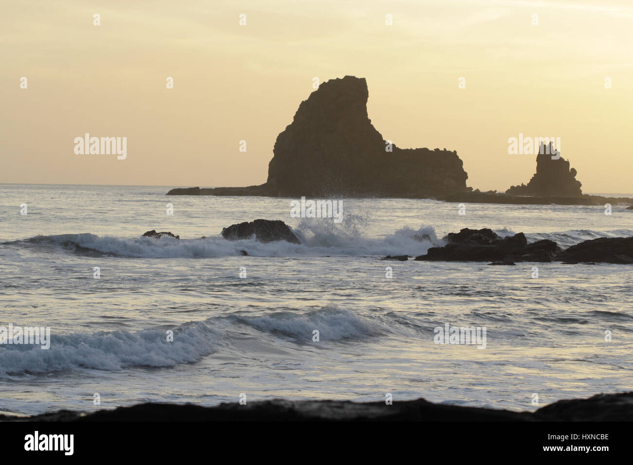 Rocks in the ocean during sunset Stock Photo - Alamy