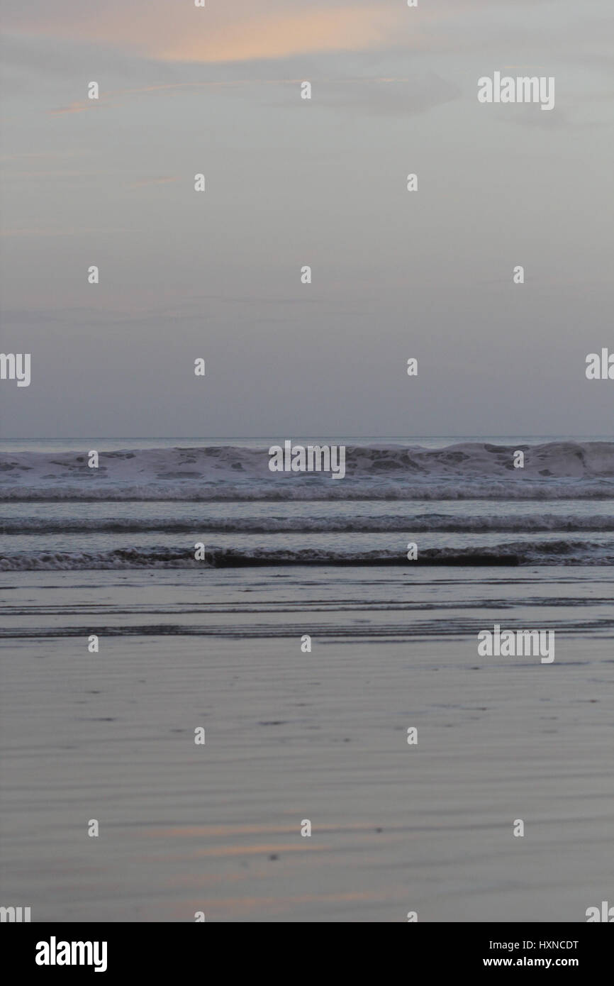 Empty beach at the sunset next to ocean Stock Photo - Alamy
