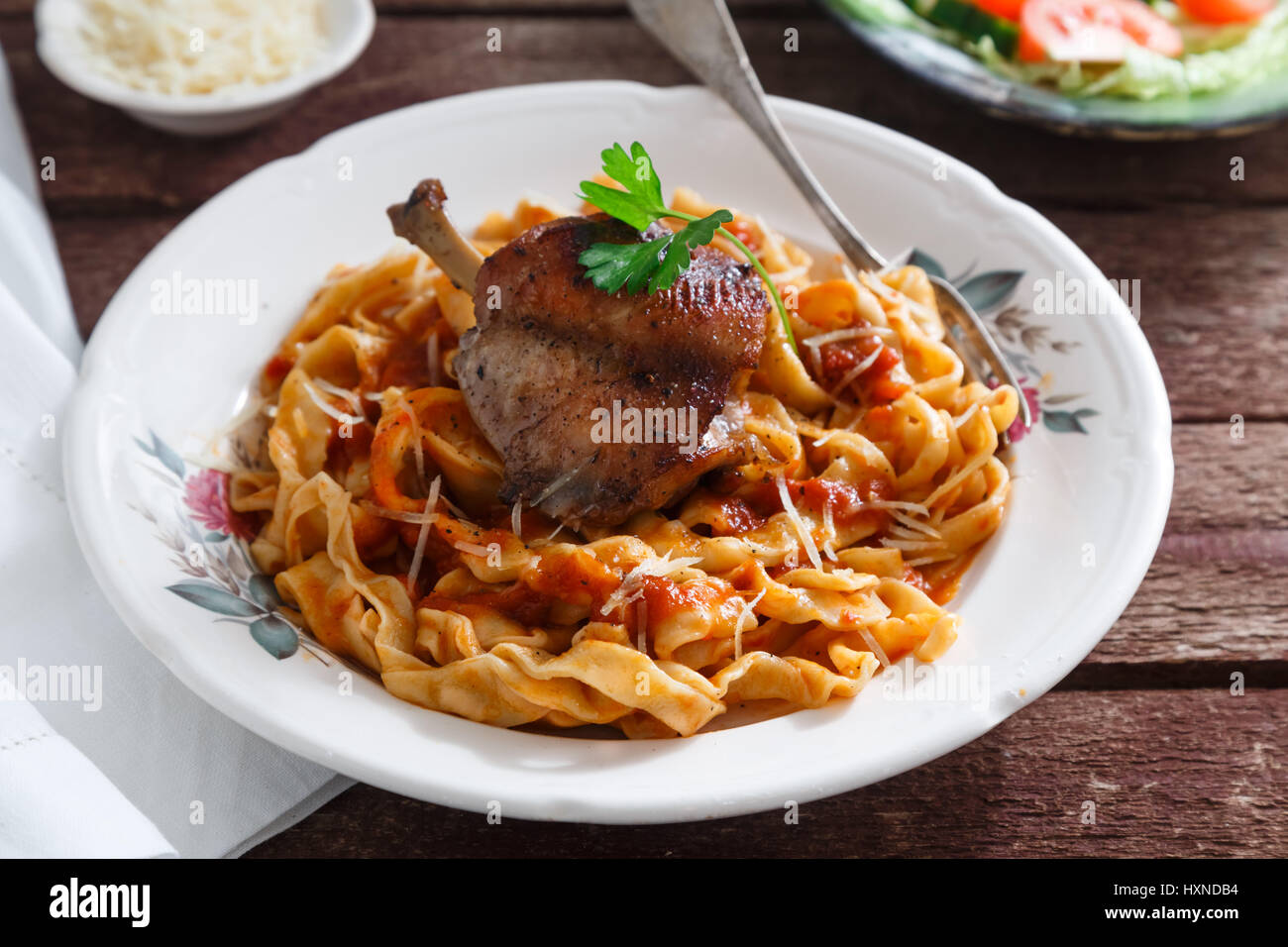 Braised Rabbit Leg in Tomato Sauce with Homemade pasta, dark rustic ...