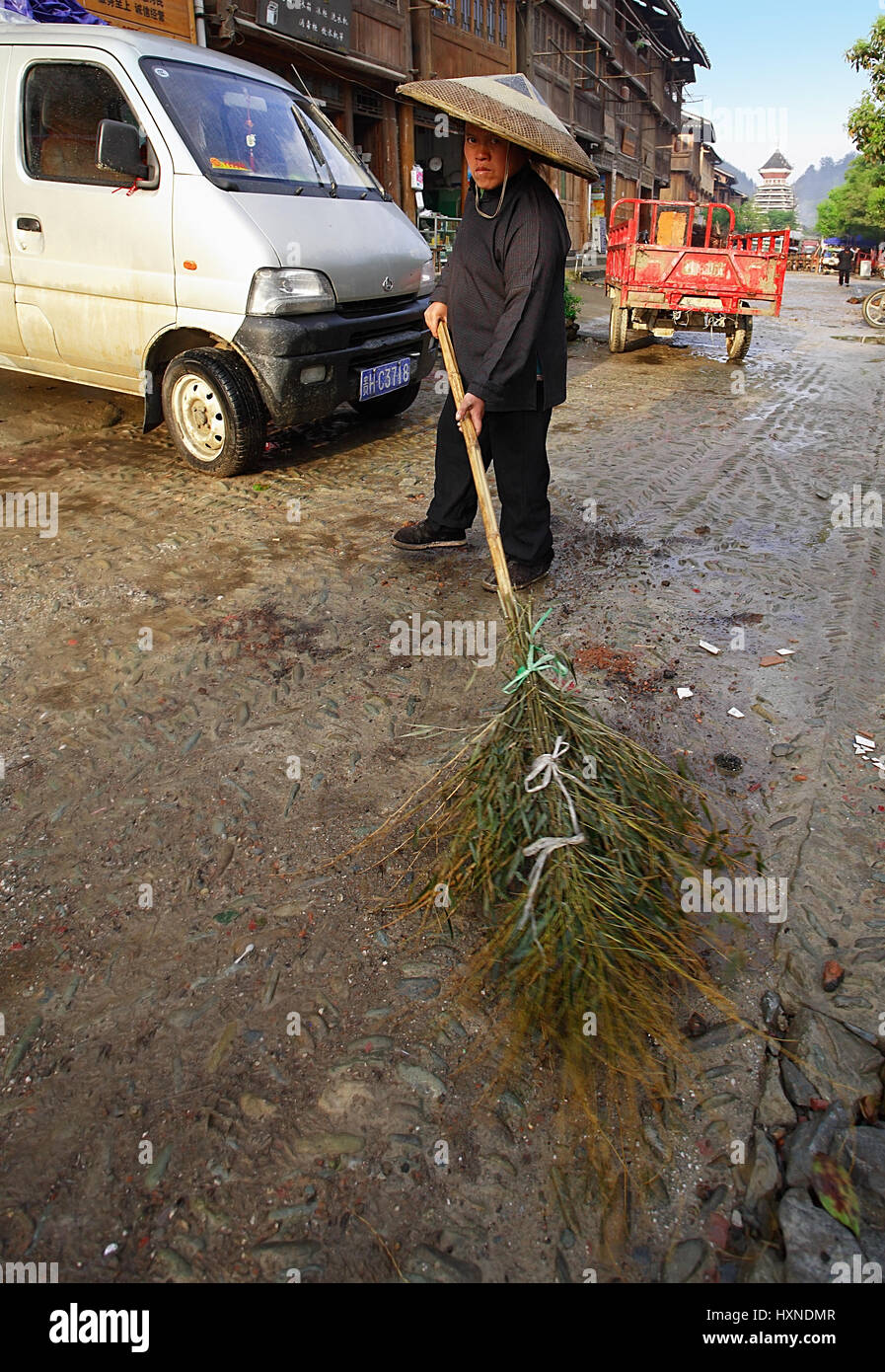 GUIZHOU PROVINCE, CHINA - APRIL 8: Chinese janitor sweeping the main ...