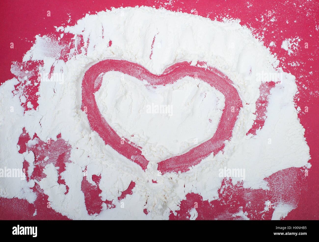 Heart drawn in scattered flour Stock Photo - Alamy