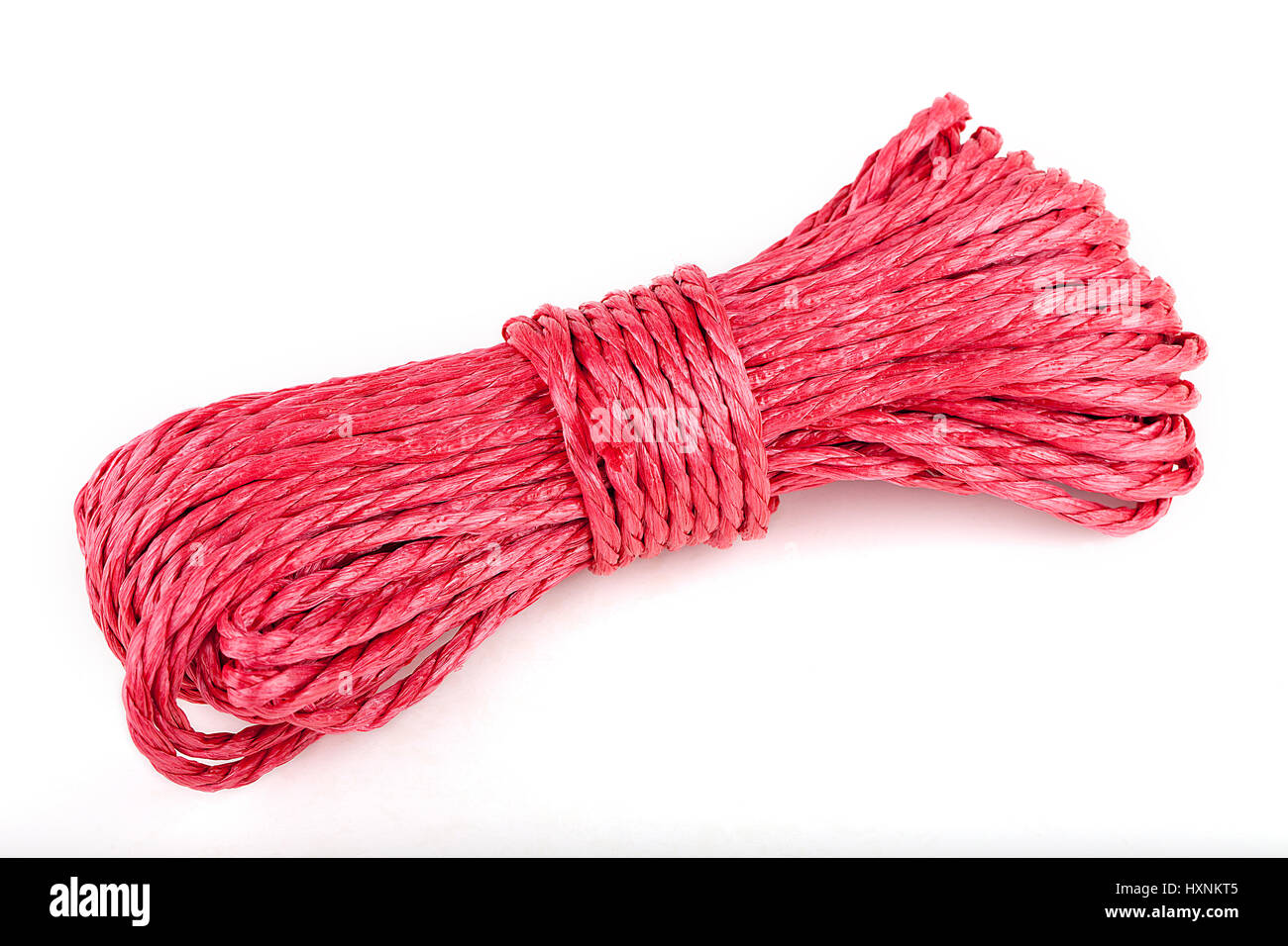 Roll of red utility rope isolated on white background Stock Photo - Alamy