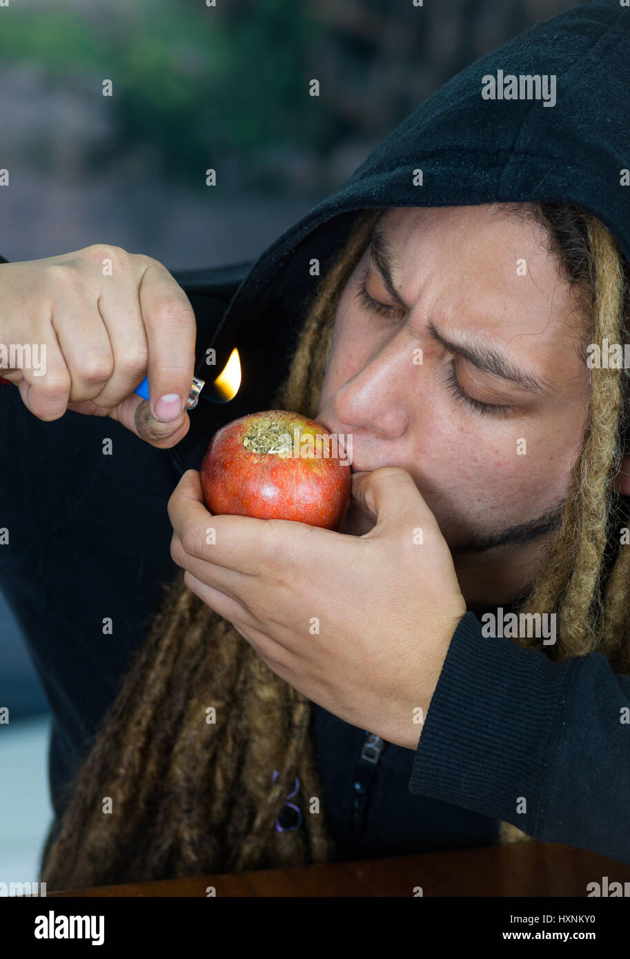 Man smoking from homemade apple bong, drug addiction concept Stock ...