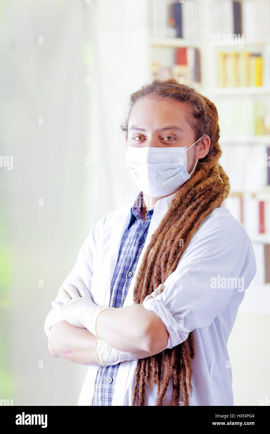Young doctor with long dread locks posing for camera, wearing facial ...