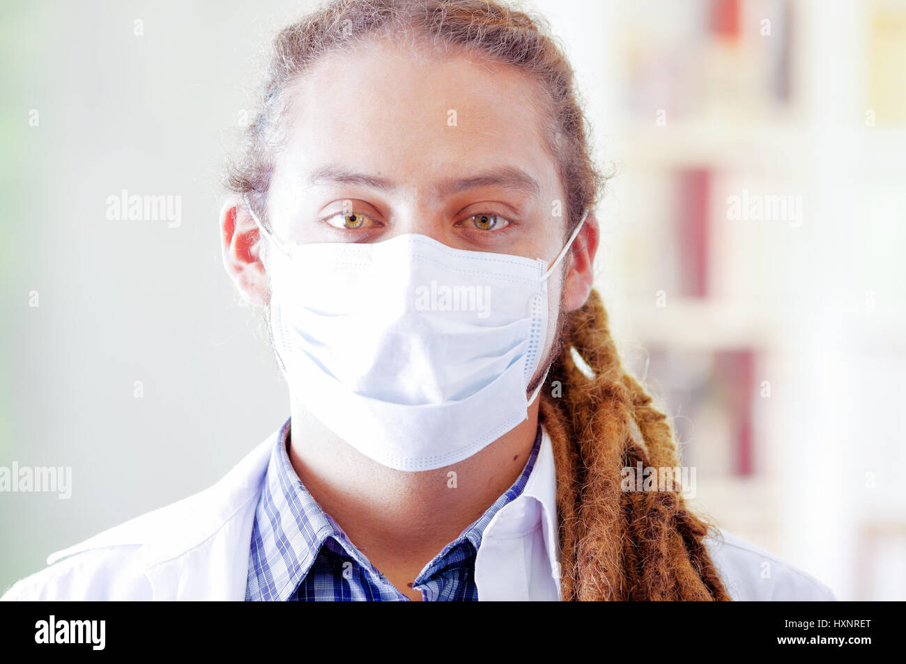 Young doctor with long dread locks posing for camera, wearing facial ...
