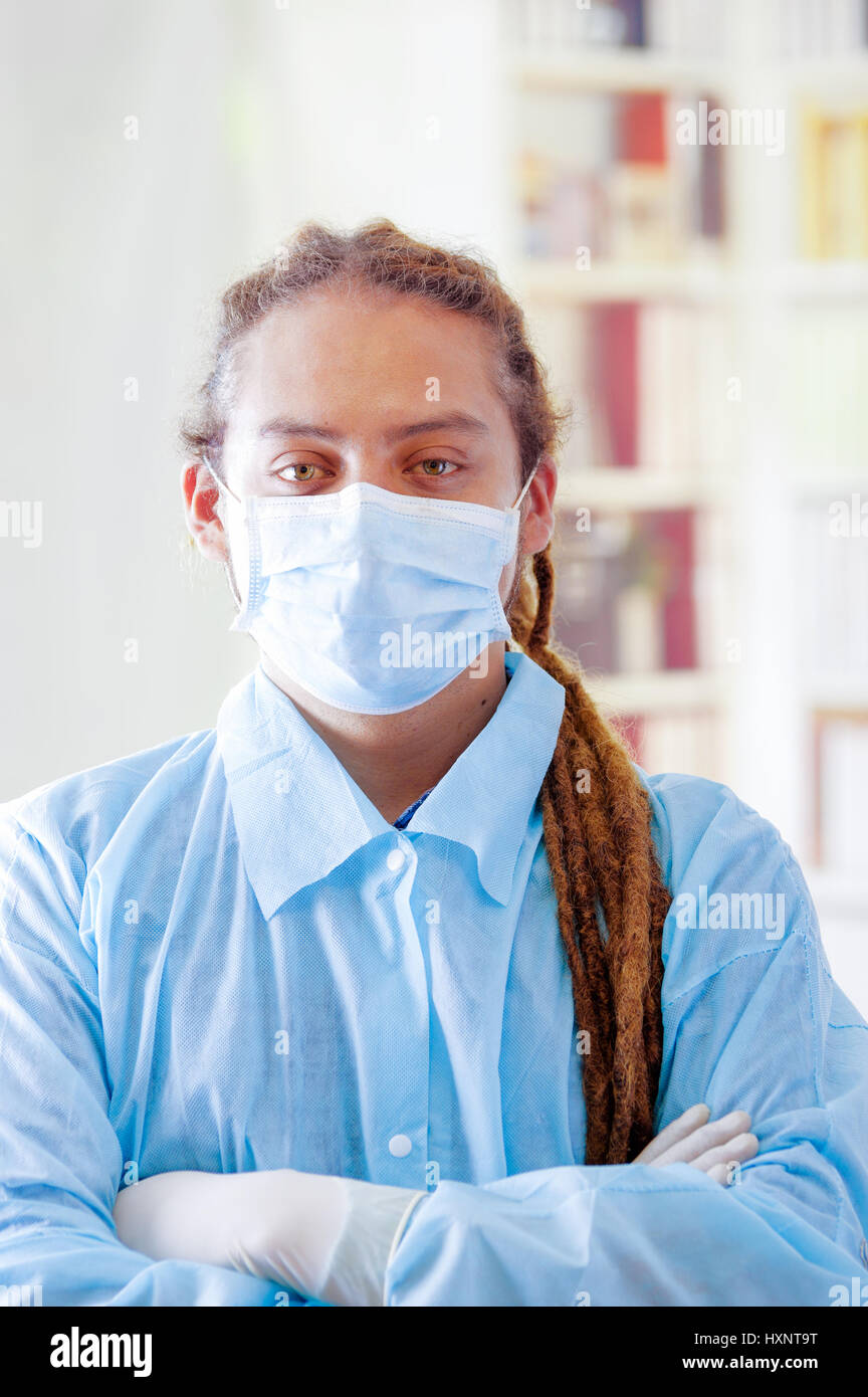 Young doctor with long dread locks posing for camera, wearing facial ...