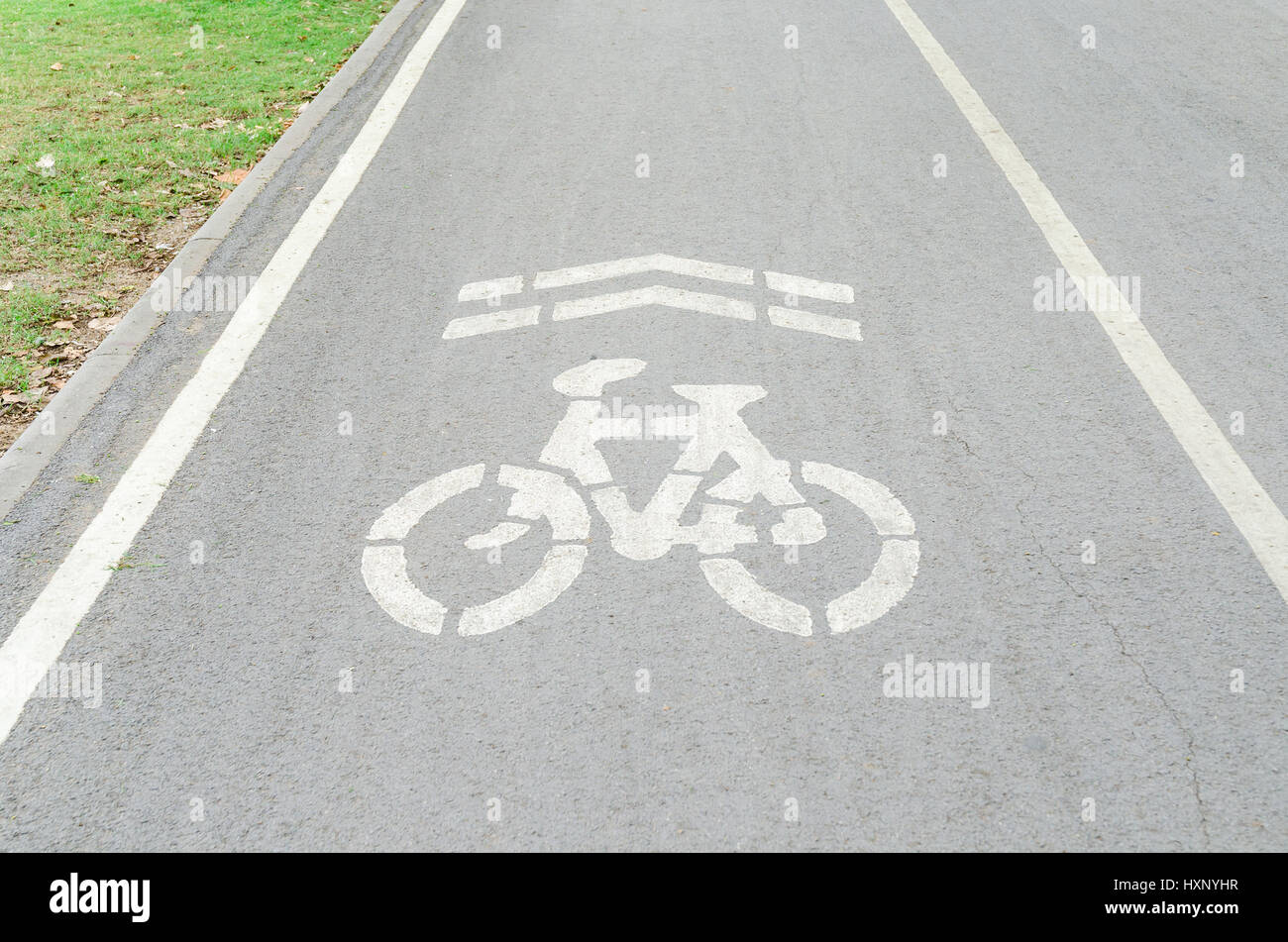 Bicycle lane sign on road Stock Photo - Alamy