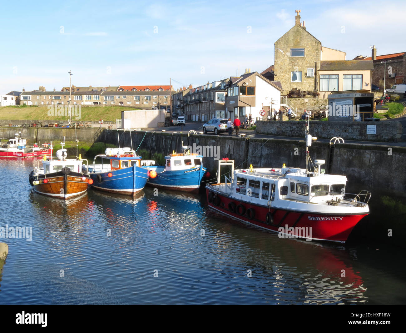 Boats in Seahouses Harbour, Northumberland, UK with Village in ...
