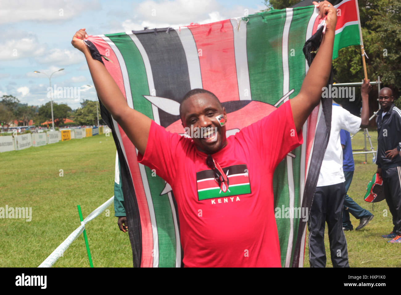 A Kenyan fan cheers of his athletes during the IAAF World Cross Country ...