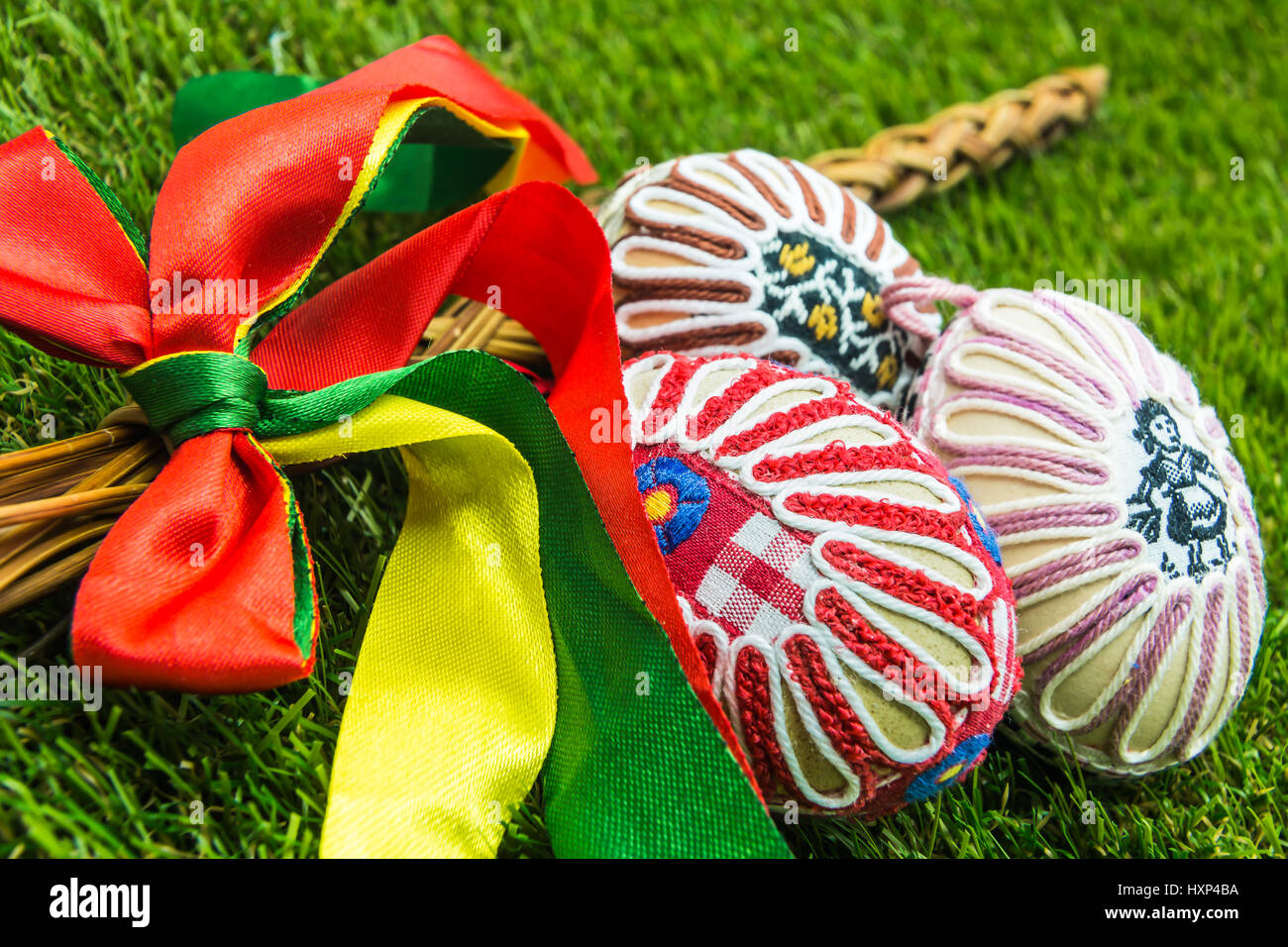 decorated Easter whip and painted decorated Easter eggs in spring grass ...