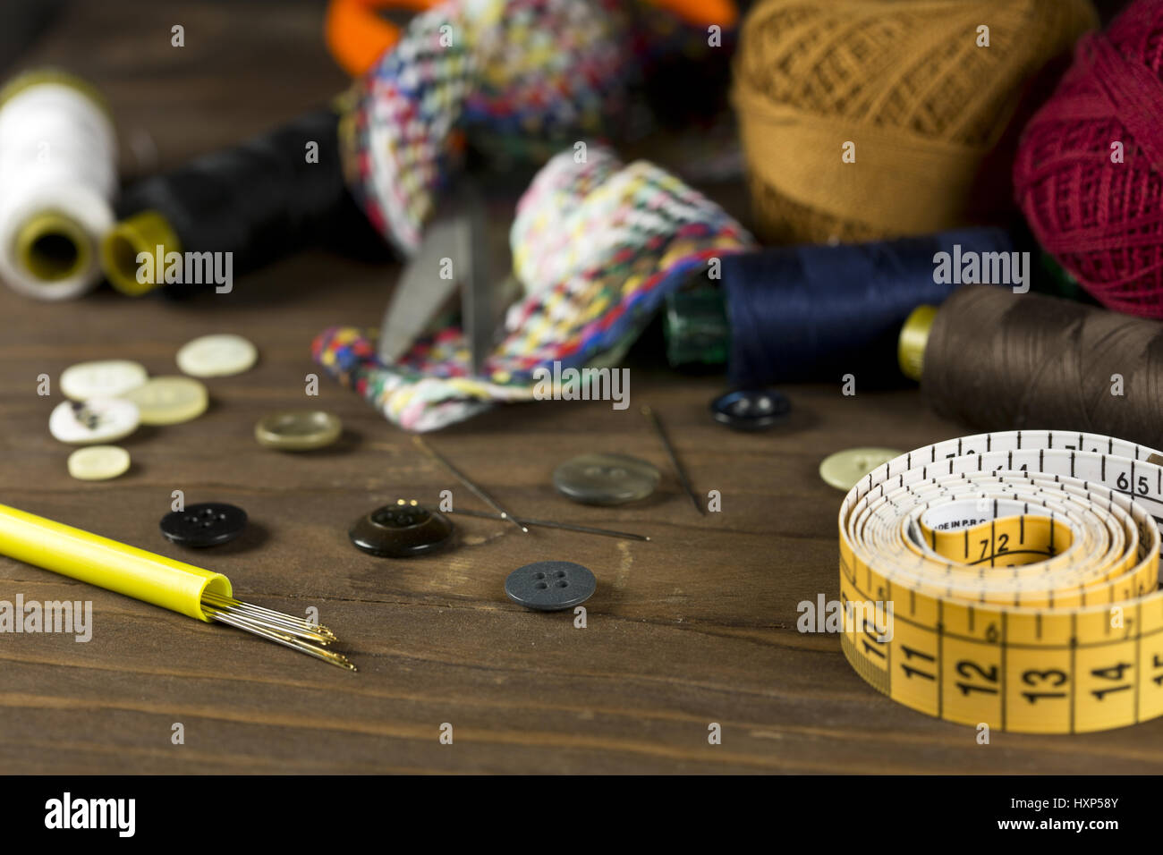 Sewing tools on a wooden background Stock Photo - Alamy