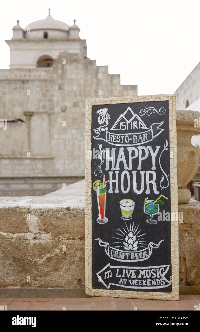 AREQUIPA, PERU - JANUARY 07, 2017: Happy hour board with text written ...