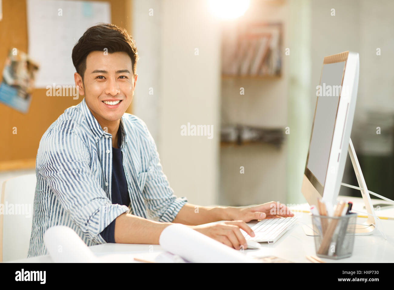 Young man using computer at home Stock Photo - Alamy